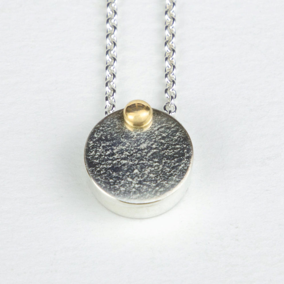 Midcentury moon locket with gold ball.